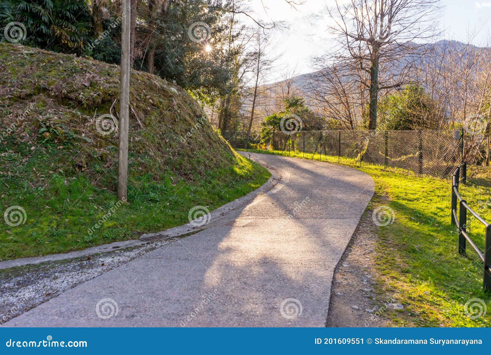 Italy, Lecco, Lake Como, a Path with Trees on the Side of a Road Stock ...