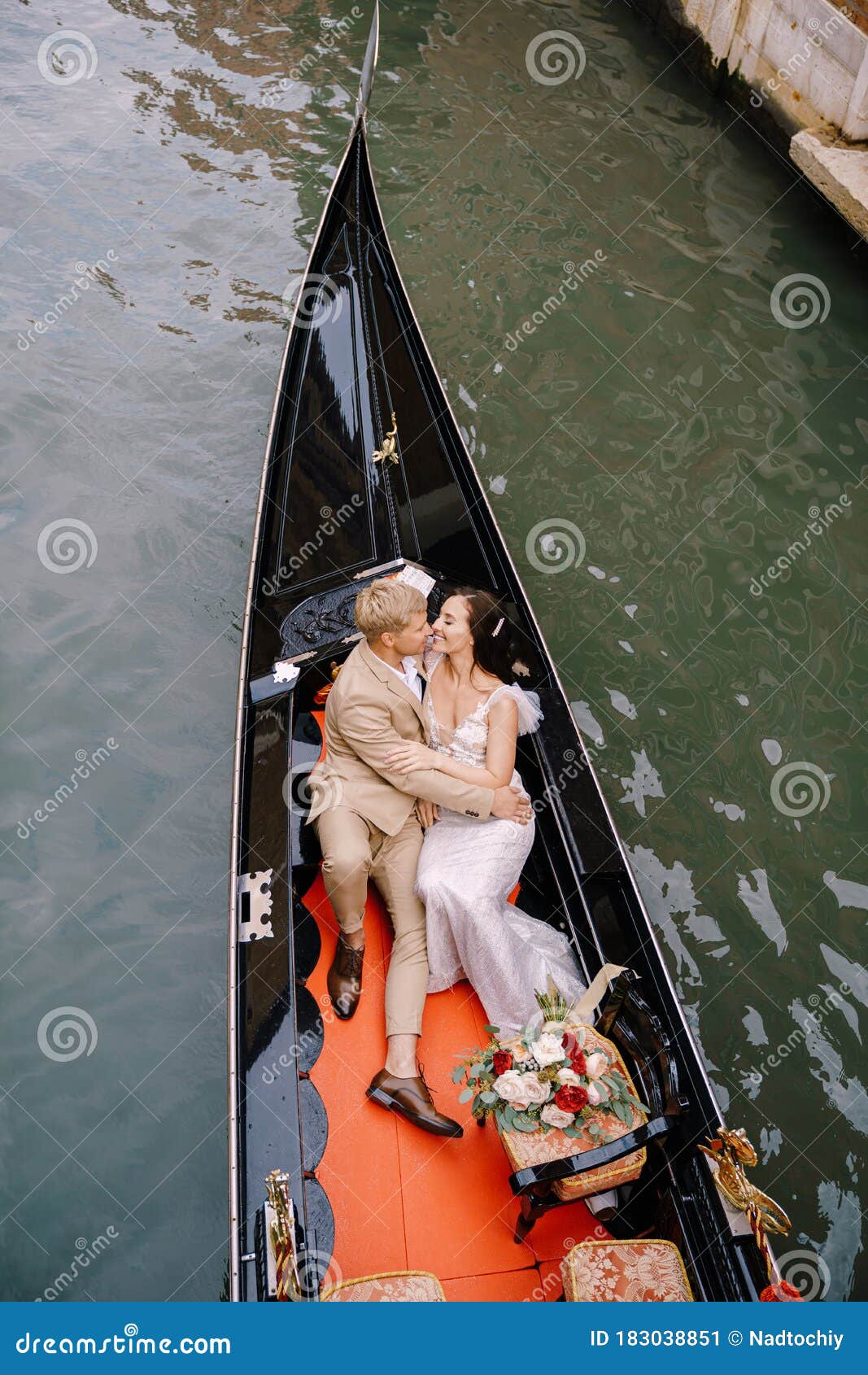 Italy Wedding In Venice A Gondolier Rolls A Bride And Groom In A