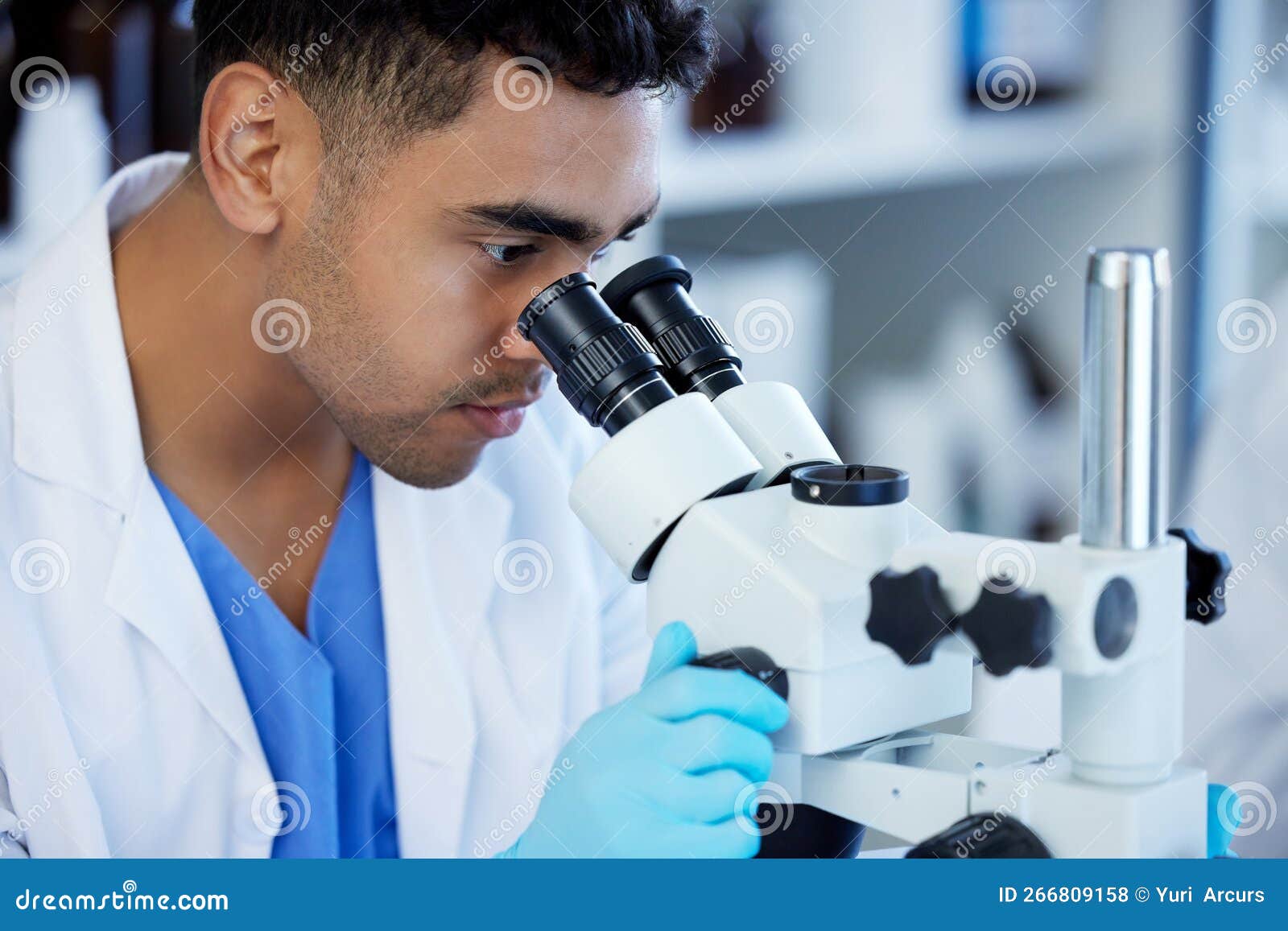 Itll Be Clearer Once I Magnify it. a Young Man Using a Microscope in a ...
