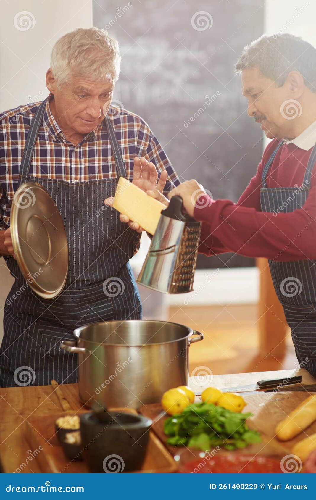 Its All about the Cheese. Two Senior Men Cooking in the Kitchen. Stock ...