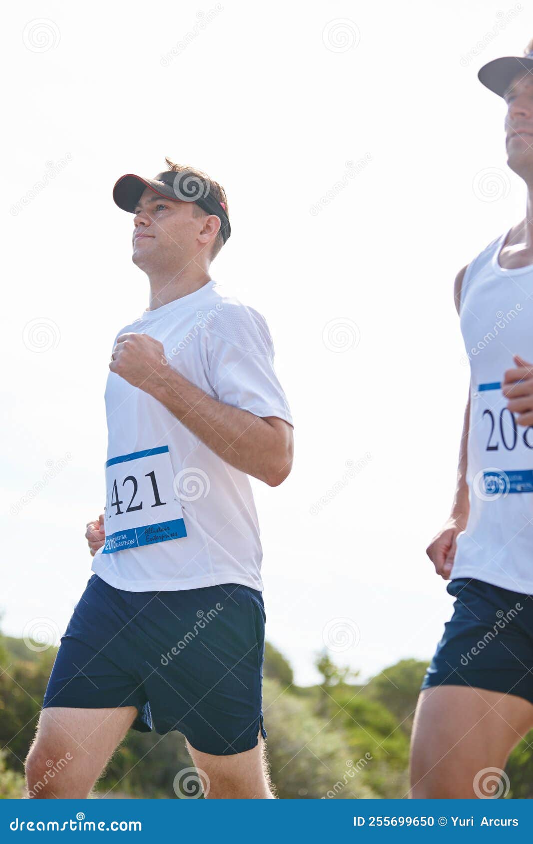 Its All about Endurance. Young Men Running a Marathon. Stock Photo ...