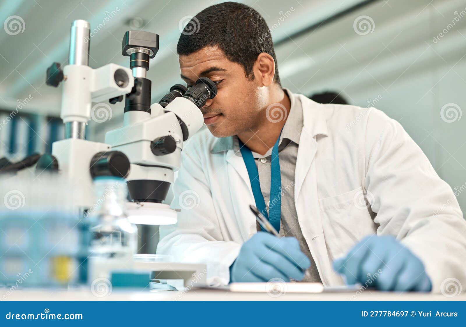 Its Been a Day Full of Tests. a Young Scientist Writing Notes while ...