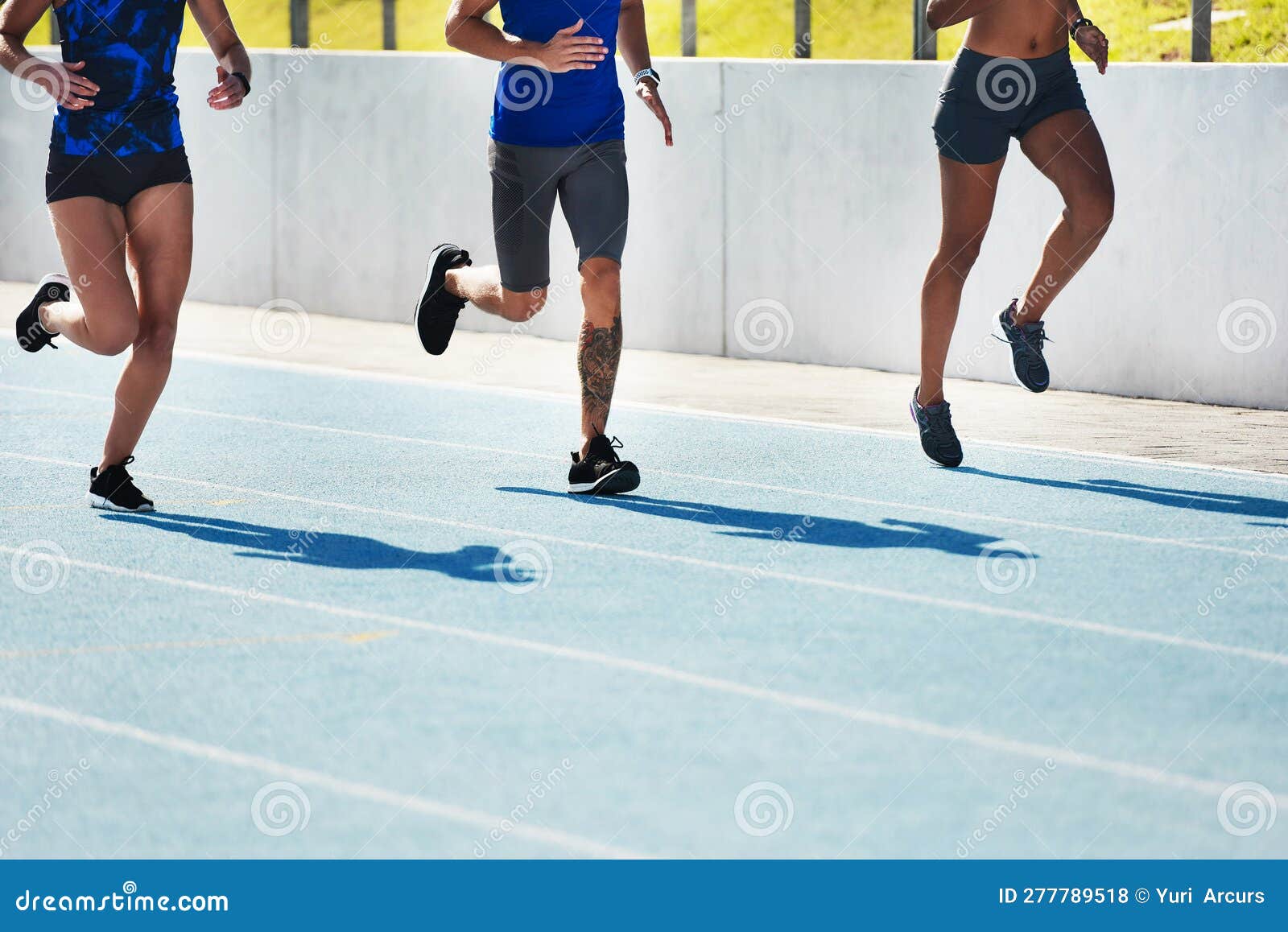 Its Down To Three. Three Unrecognizable Young Athletes Running Along ...