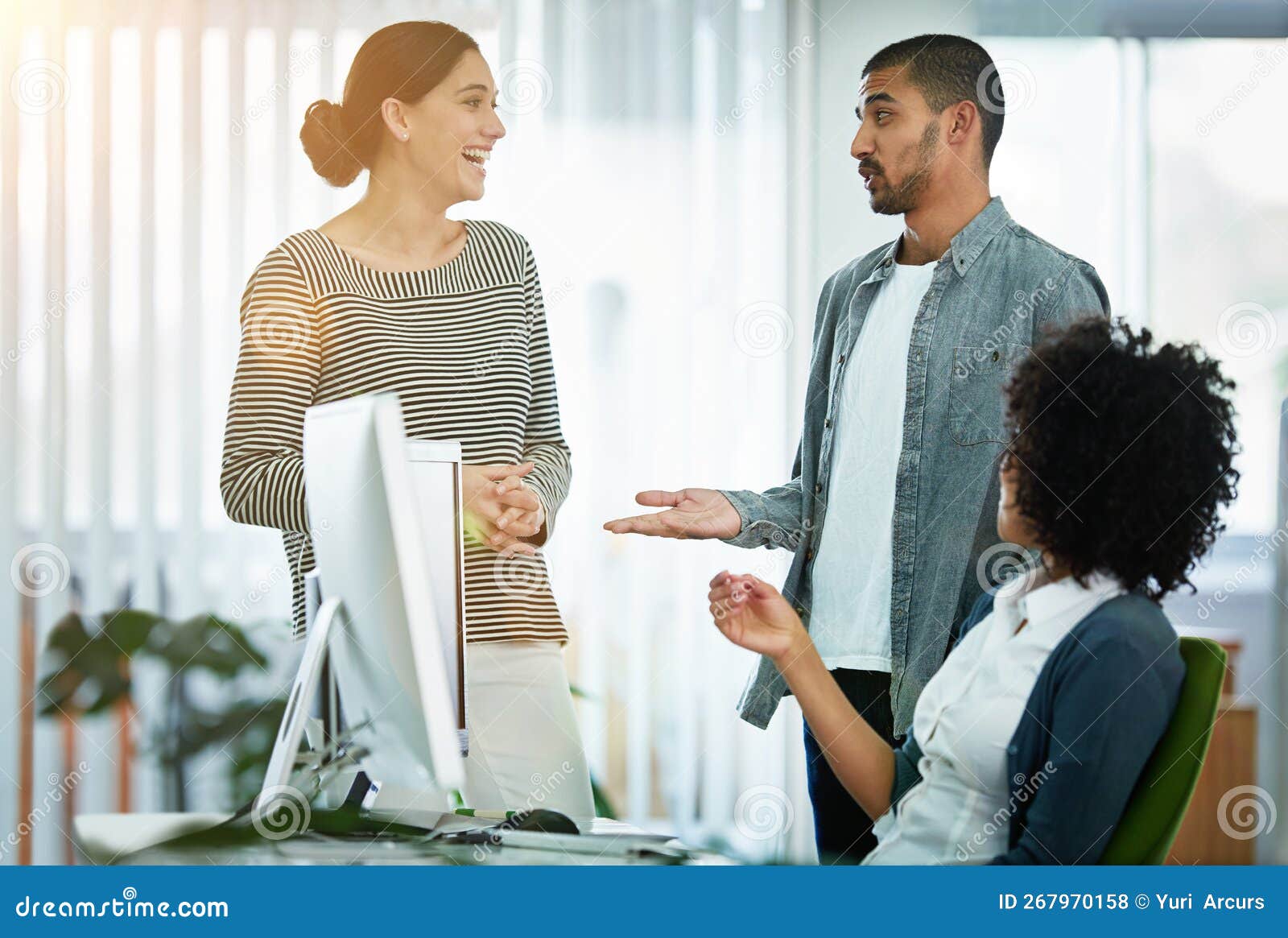 Its a Great Work Environment. Designers Talking Together at a ...