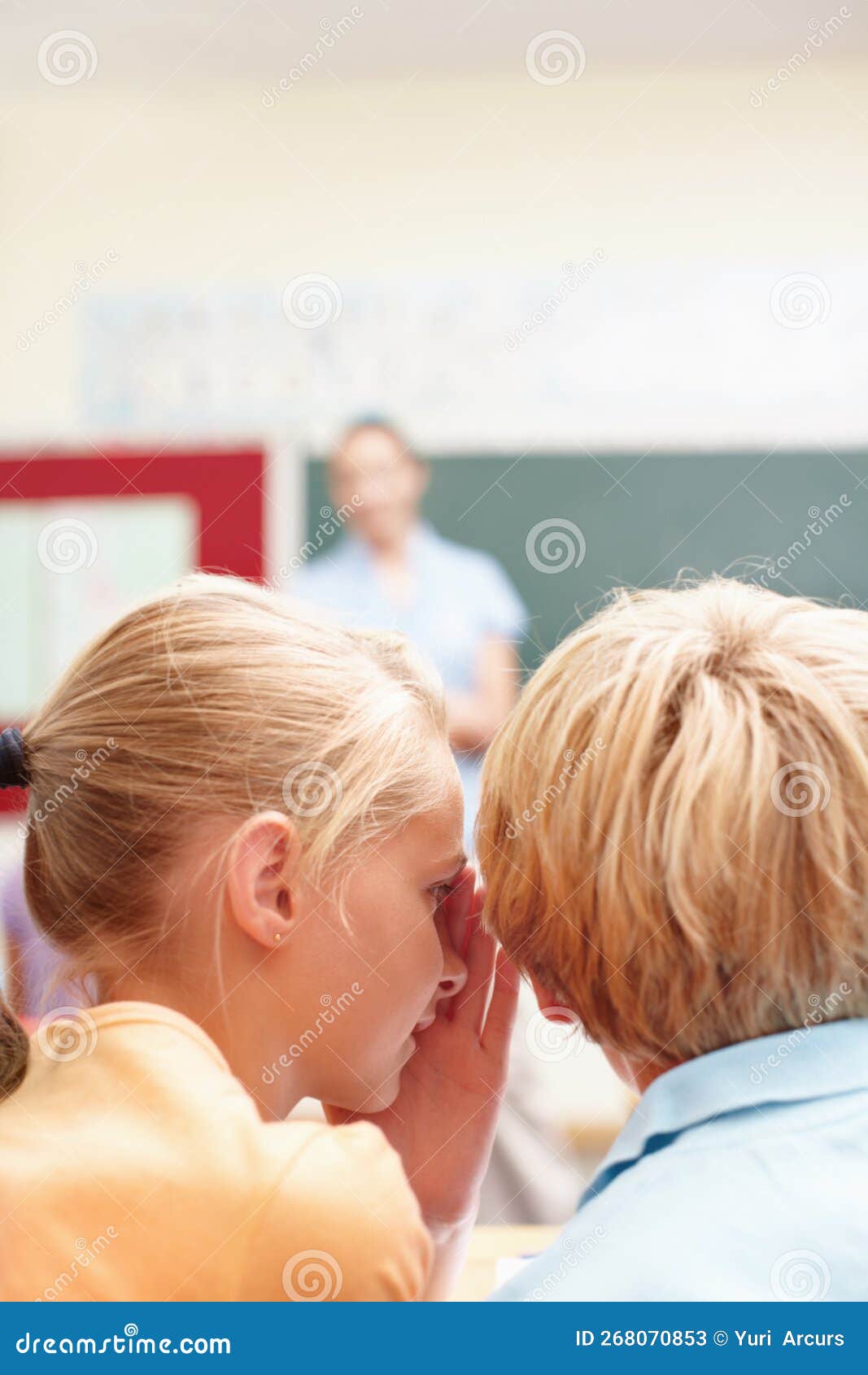 Its a Secret...Rear View of Two Students Sharing a Secret in Class ...