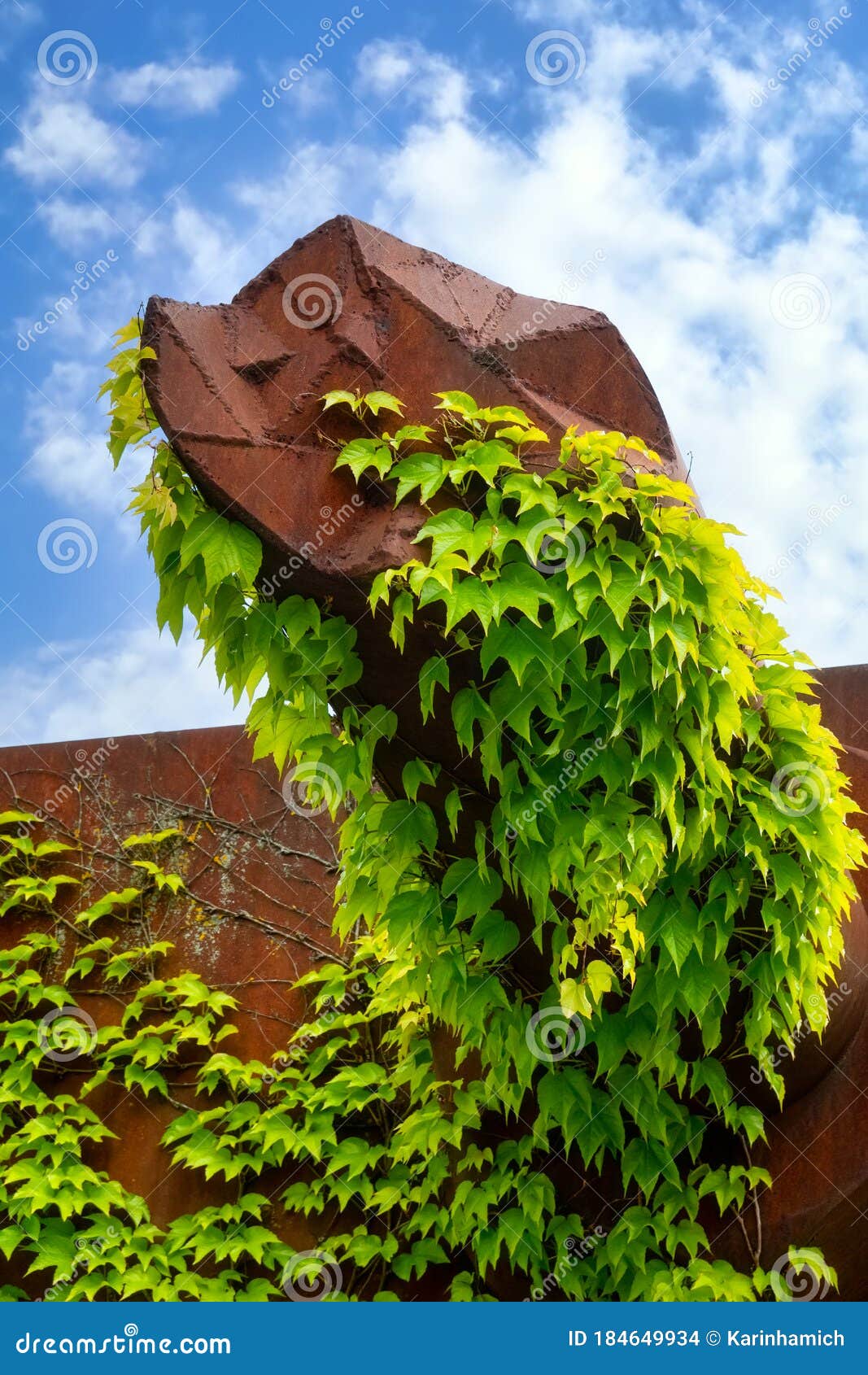 Ivy on a Decorative Column Against a Blue Cloudy Sky. Decoration of a ...