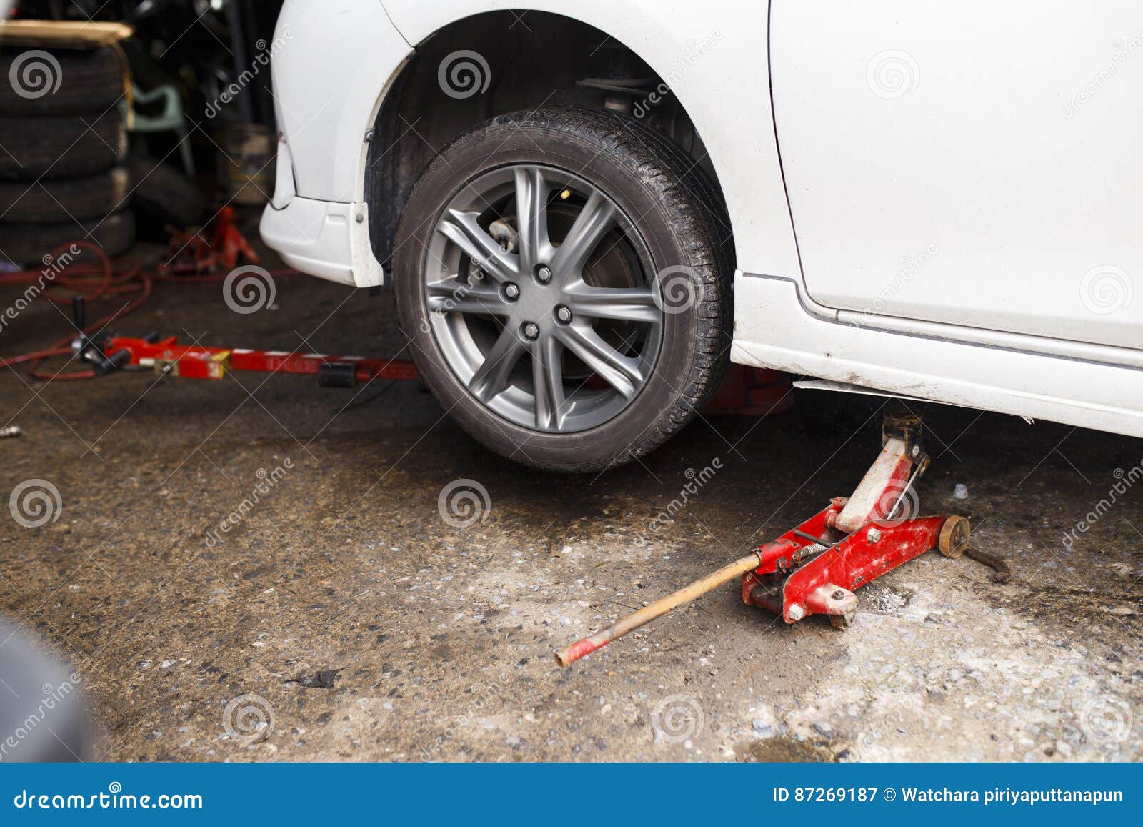 Jacking Up A Car To Change A Tire. Replacing Car Wheel Using Hydraulic ...