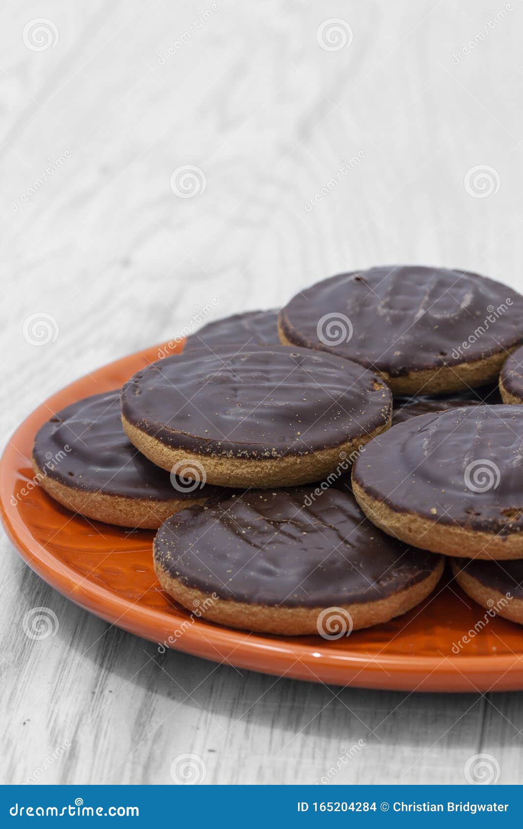 Jaffa Cakes Biscuits Stacked on an Orange Plate. Stock Photo - Image of ...