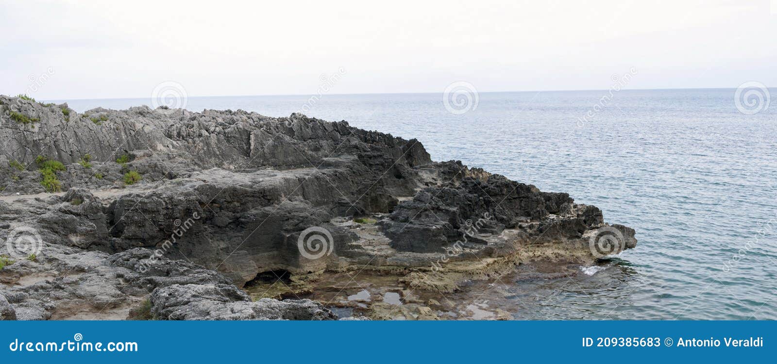 A Jagged Cliff Overhanging with the Horizon in the Background. Sea ...