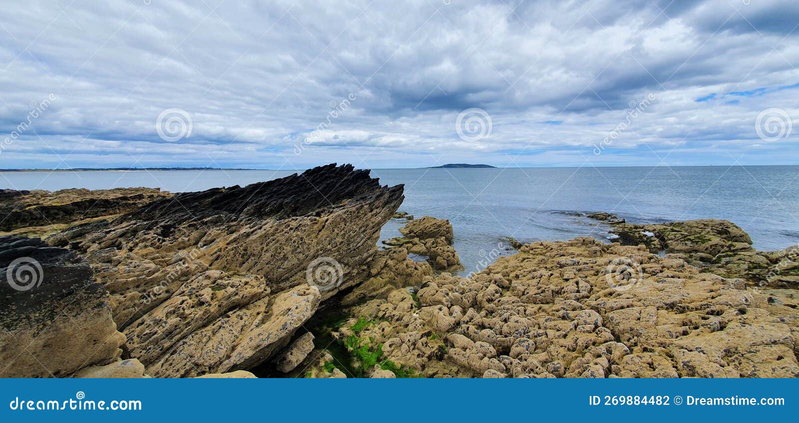 Jagged rocks by the sea stock photo. Image of terrain - 269884482