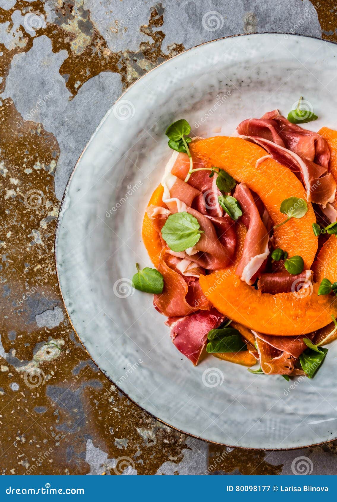 Jamon Serrano Prosciutto, Melon and Arugula Salad on Grey Plate Stock ...