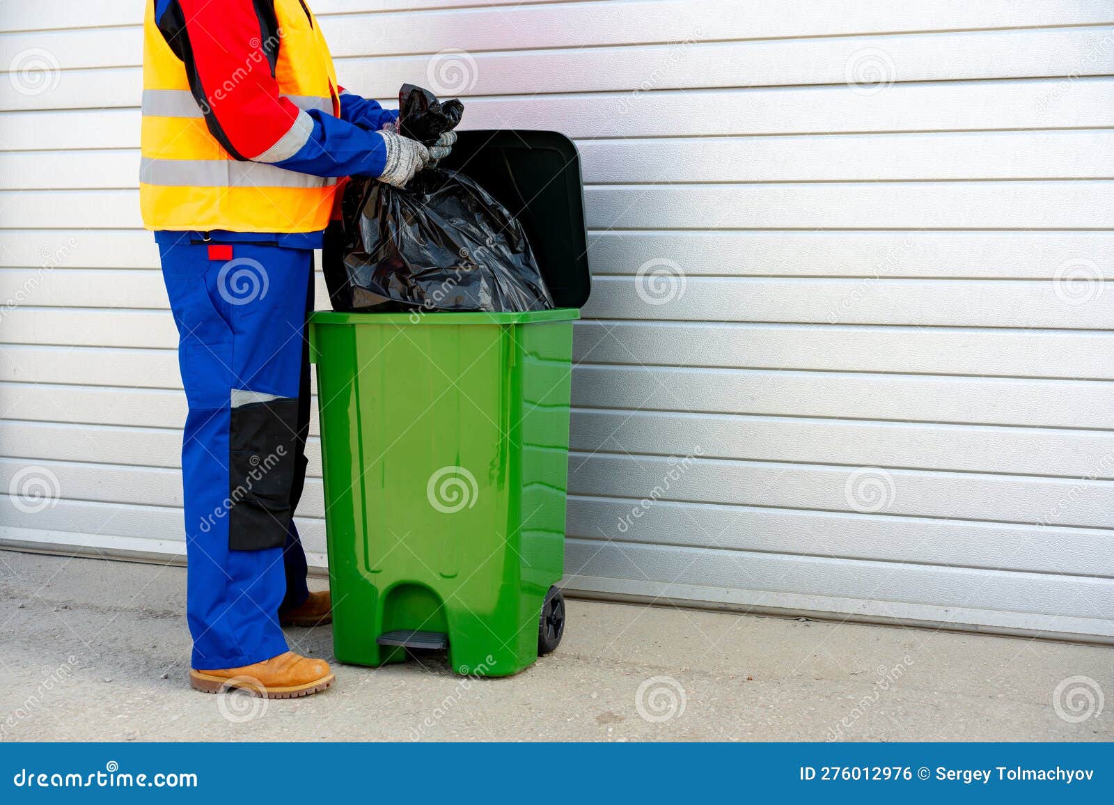 Janitor Takes Garbage Out of Trash Container Outdoors Stock Photo ...