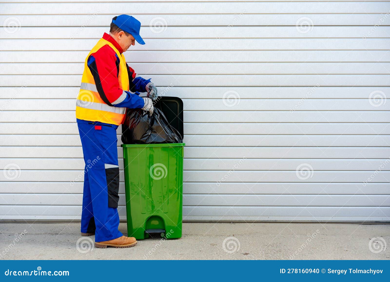 Janitor Takes Garbage Out of Trash Container Outdoors Stock Photo ...