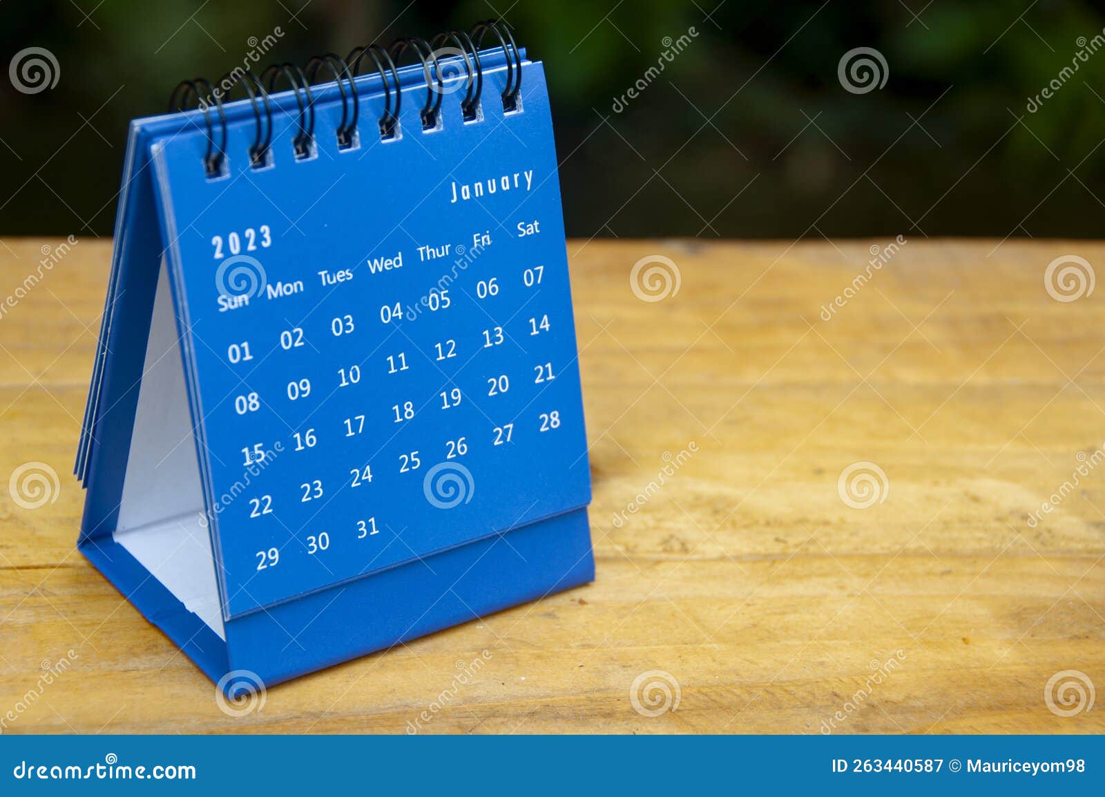 January 2023 Blue Desk Calendar on Wooden Table Background with ...