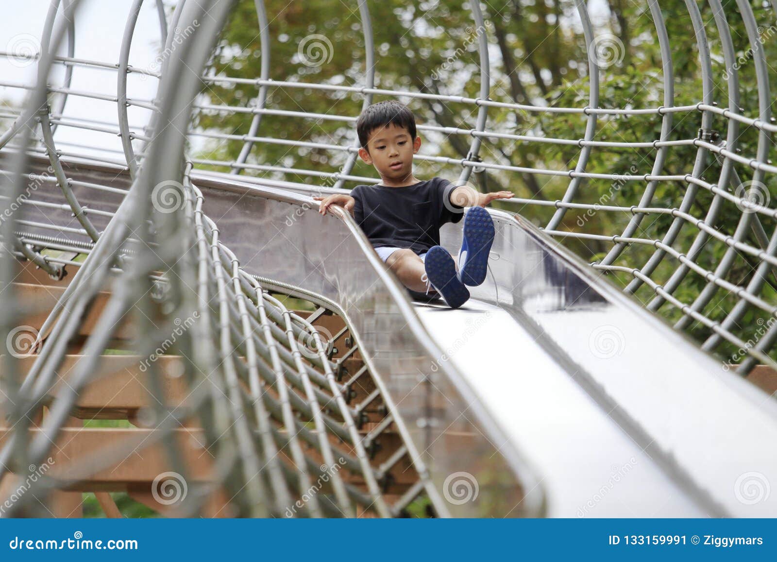Japanese boy on the slide stock image. Image of smiling - 133159991