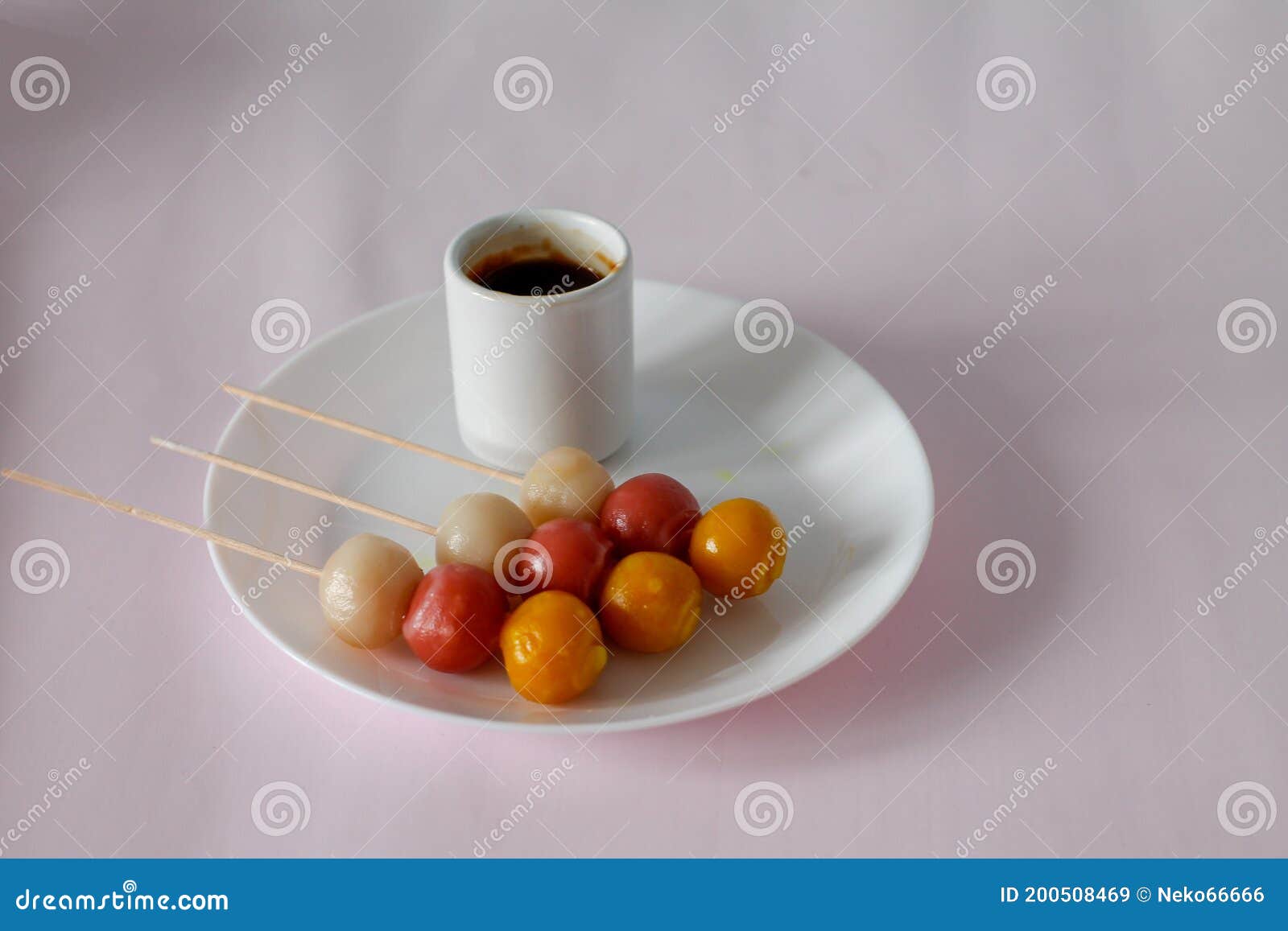 Japanese Dango Treat on White Plate and Pink Background Stock Image ...