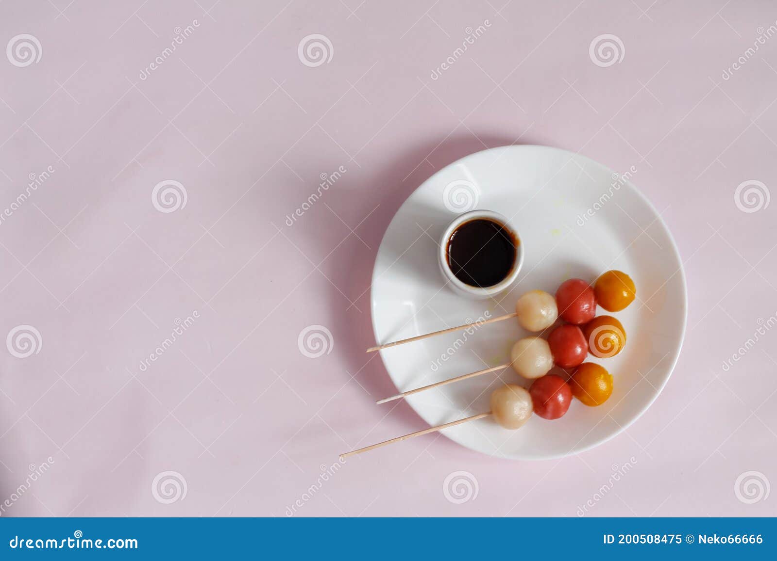 Japanese Dango Treat on White Plate and Pink Background Stock Image ...