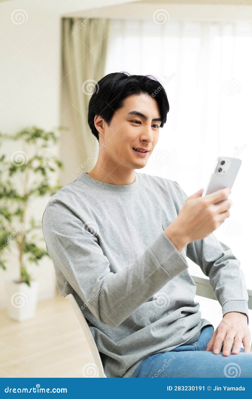 Man operating a smartphone stock image. Image of asian - 283230191