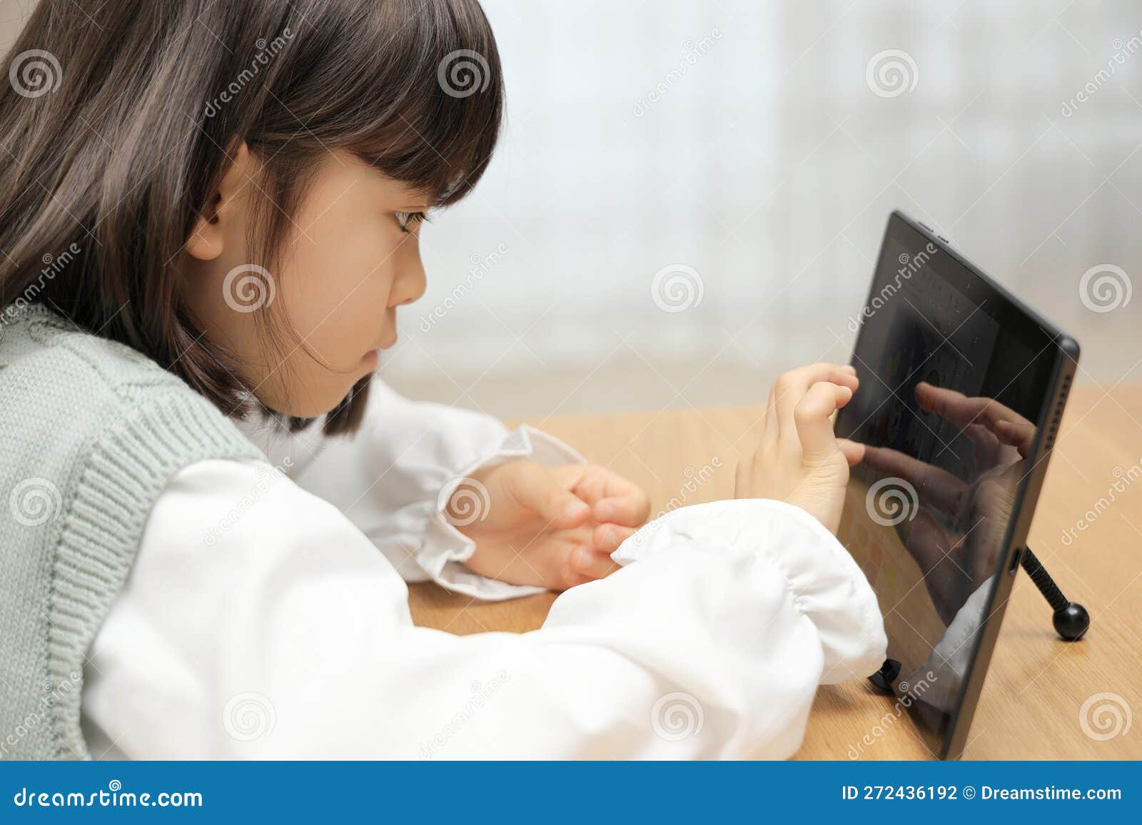 Japanese Student Girl Using a Tablet PC in Dining Room Stock Photo ...
