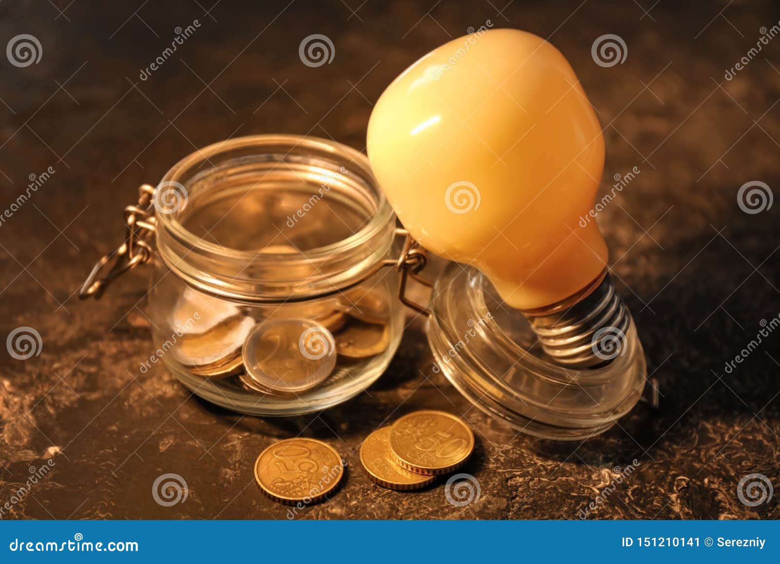 Jar with Coins and Light Bulb on Dark Table. Electricity Saving Concept ...