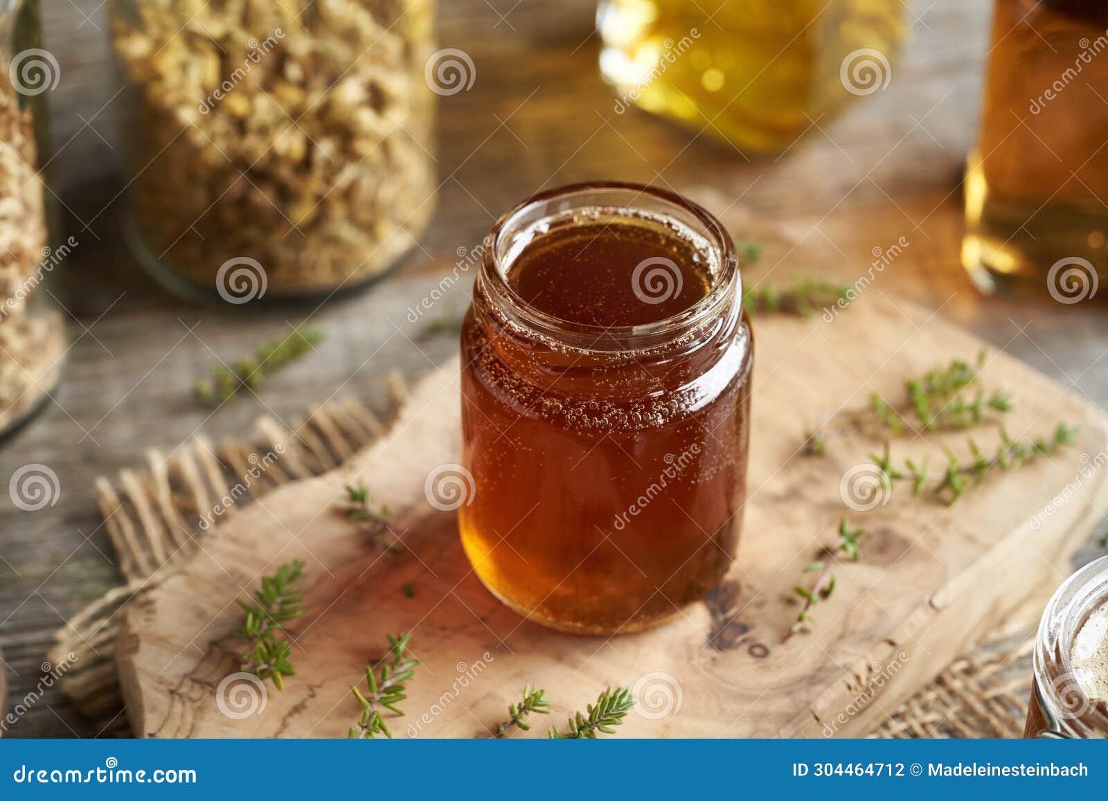A Jar of Herbal Syrup with Fresh Thyme Plant Stock Photo - Image of ...