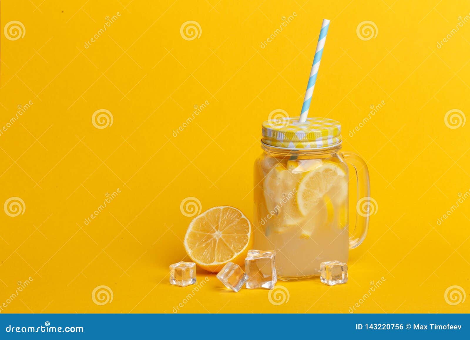 A Jar of Homemade Lemonade and Lemons on a Yellow Background Stock ...