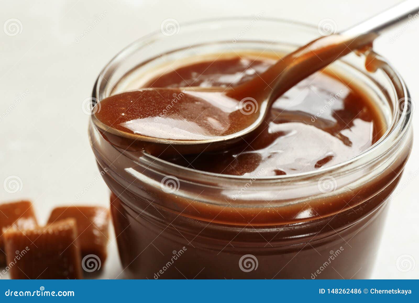 Jar with Tasty Caramel Sauce and Spoon on Table Stock Photo - Image of ...