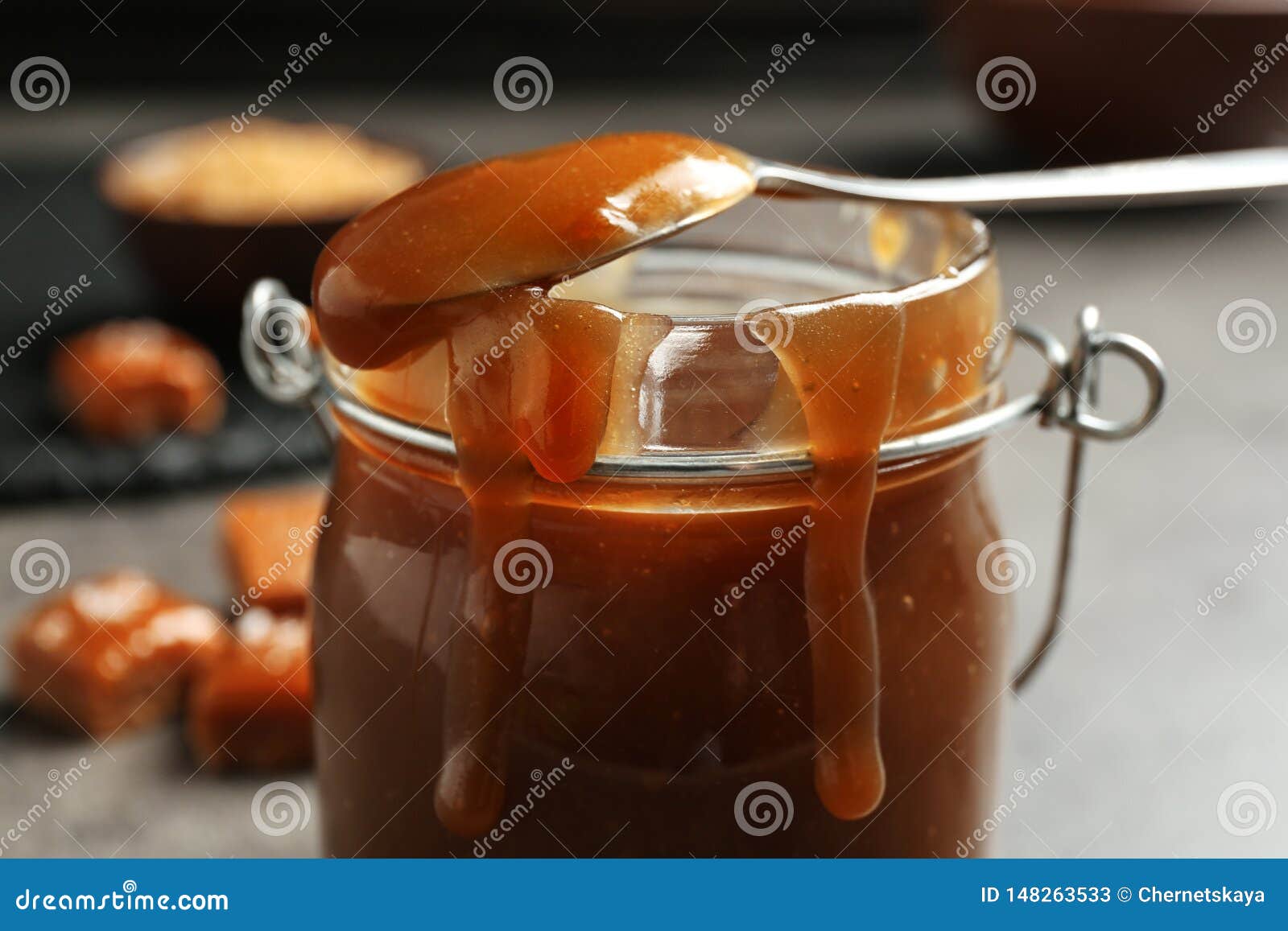 Jar with Tasty Caramel Sauce and Spoon on Table Stock Image - Image of ...