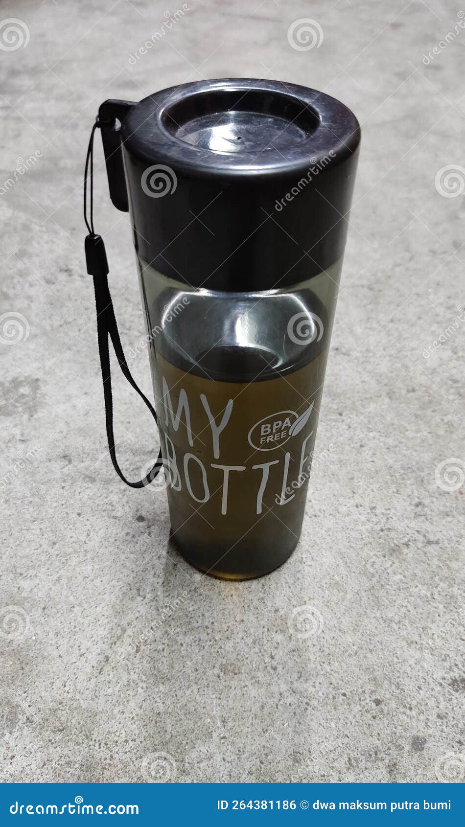 Jasmine Tea in the Black Bottle on the Sandy Grey Floor Stock Photo ...