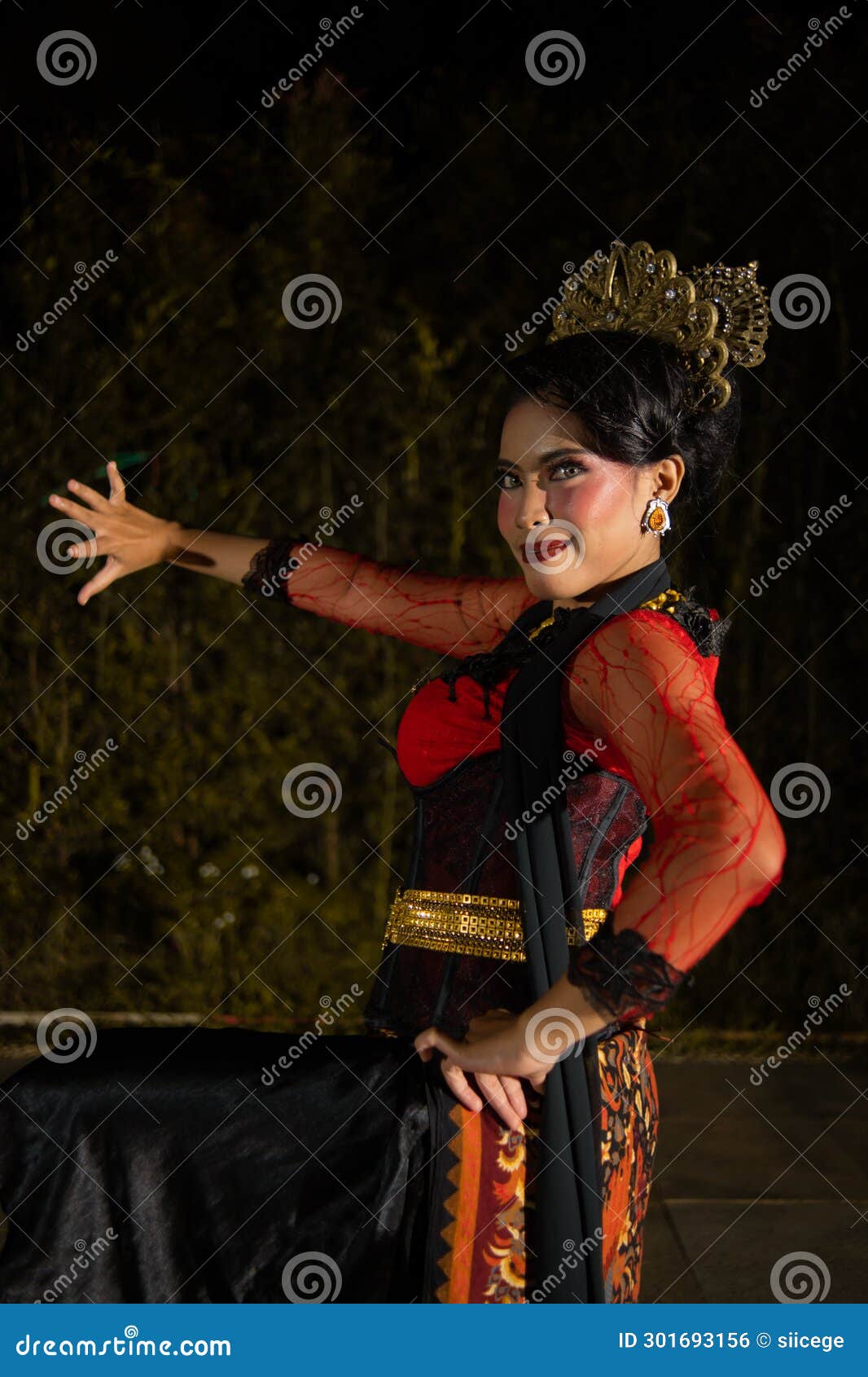 A Javanese Dancer Dancing with Gold Accessories and a Face Full of ...