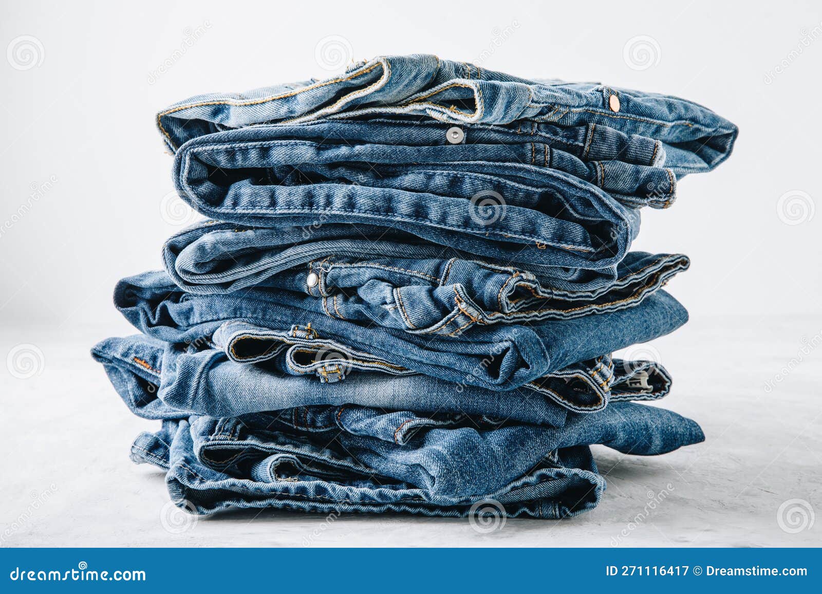 Jeans. Blue Jeans Trousers Stack on Light Stone Background Stock Image ...