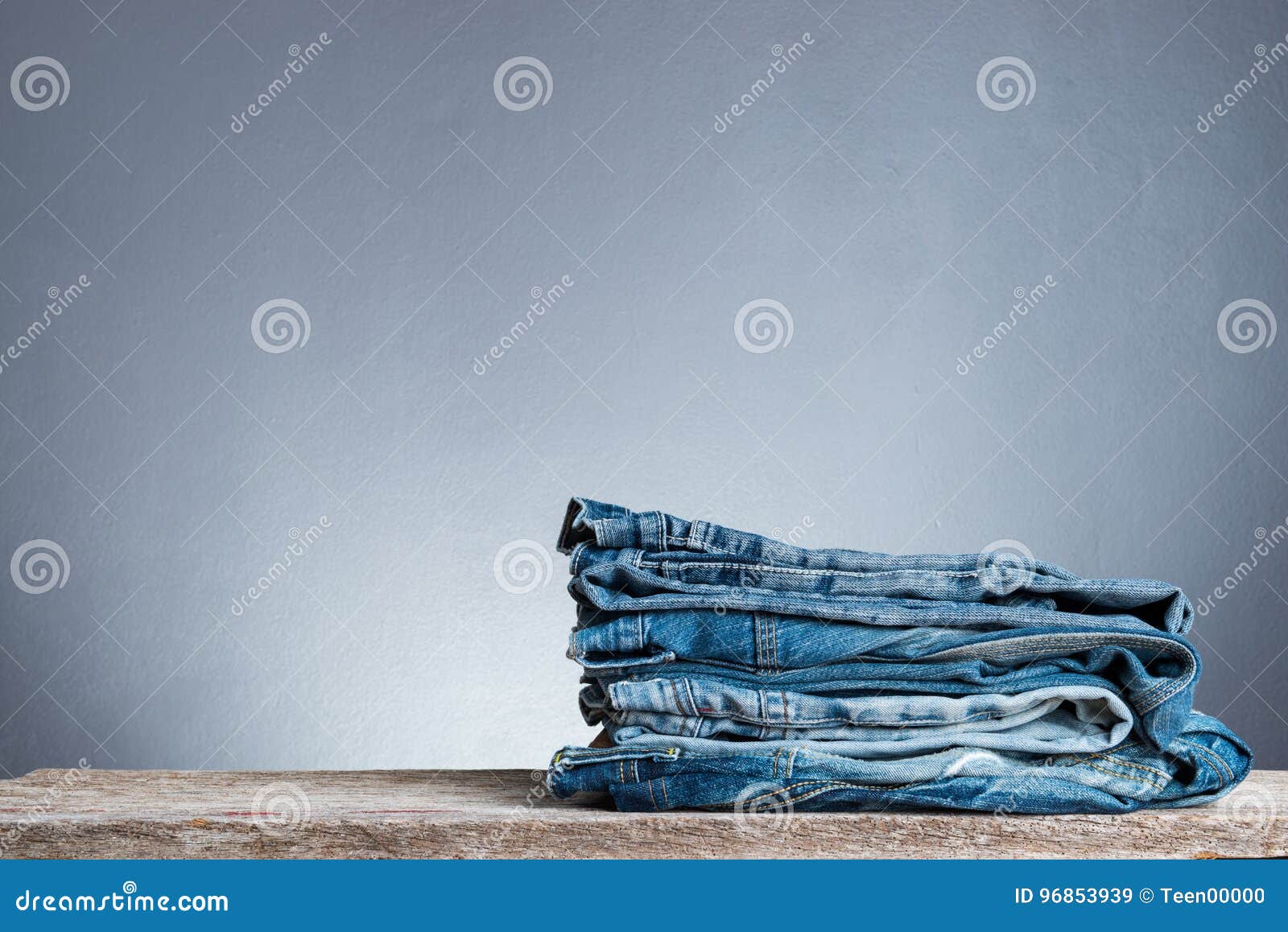 Jeans Stacked on a Wood Background Stock Image - Image of navy ...