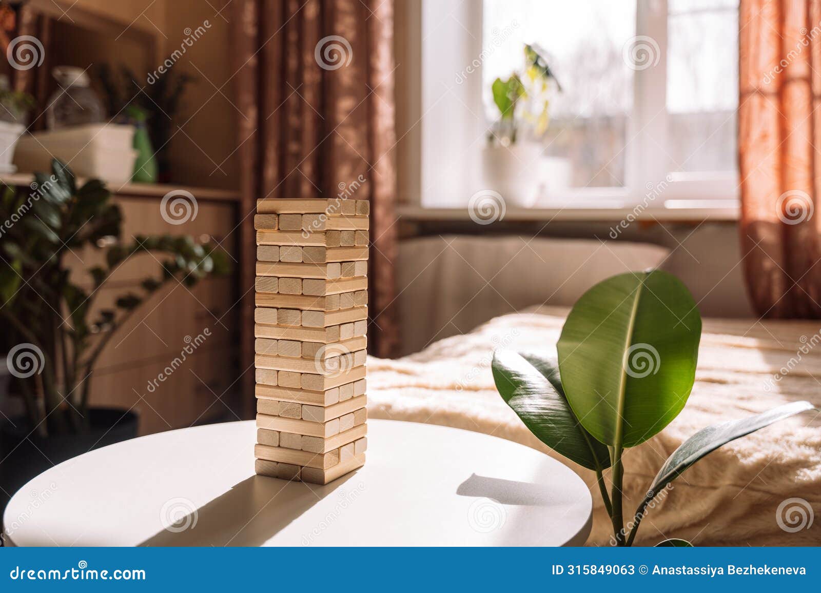 Jenga Under Sunlight on a White Table in a Room Opposite the Window ...