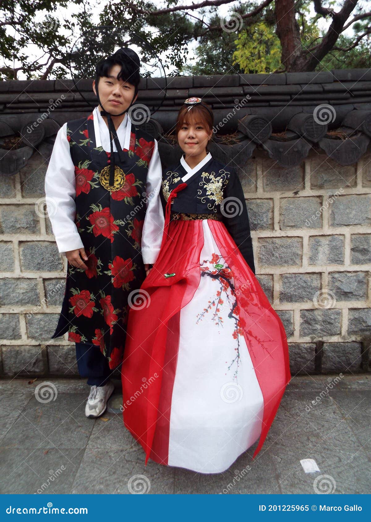 A Couple Wearing Hanbok Traditional Korean Dress On A Jeonju Street