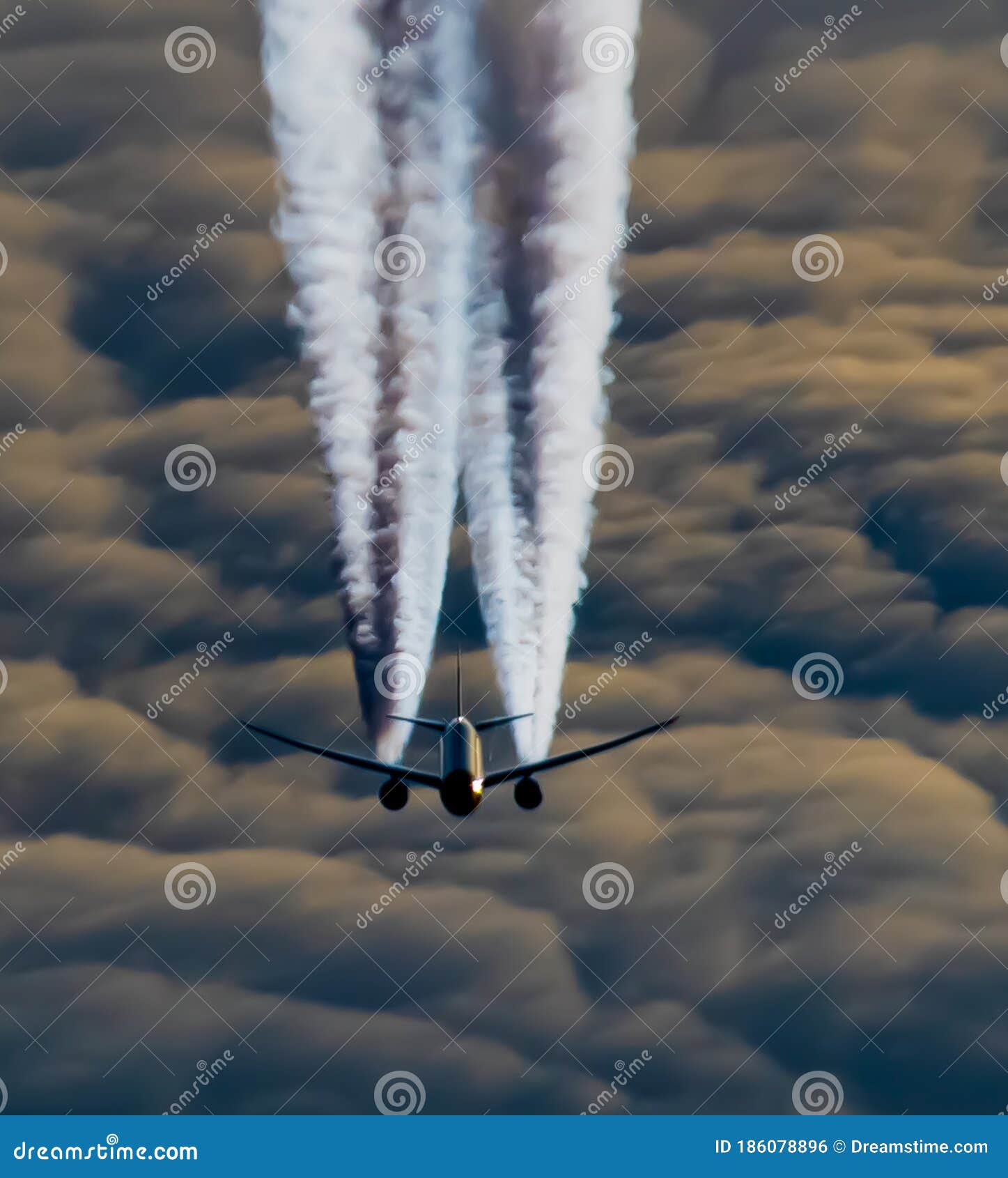 A Jet Airliner Approaching Form Below with a Contrail at High Altitude ...