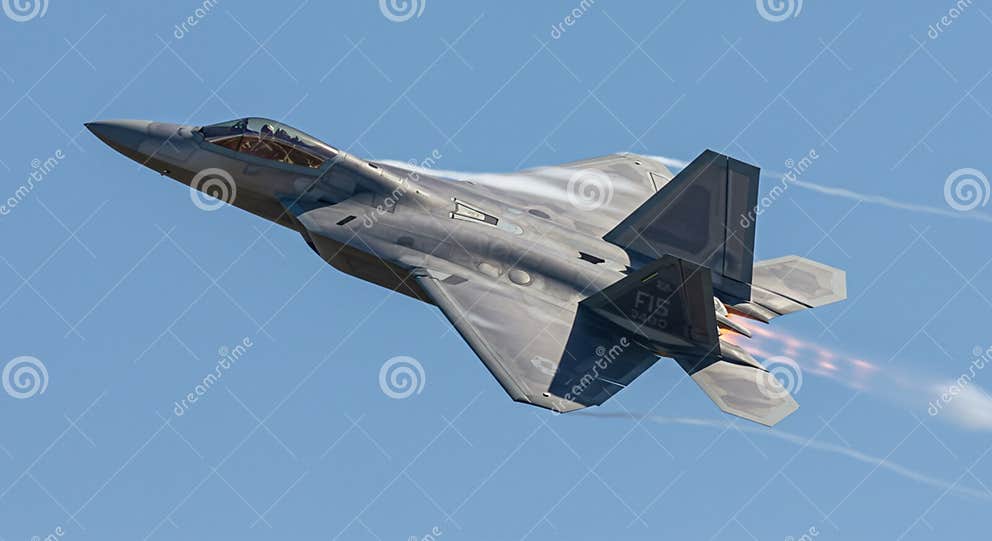 A Jet Fighter is Soaring through the Clear Blue Sky, Angled Upwards ...