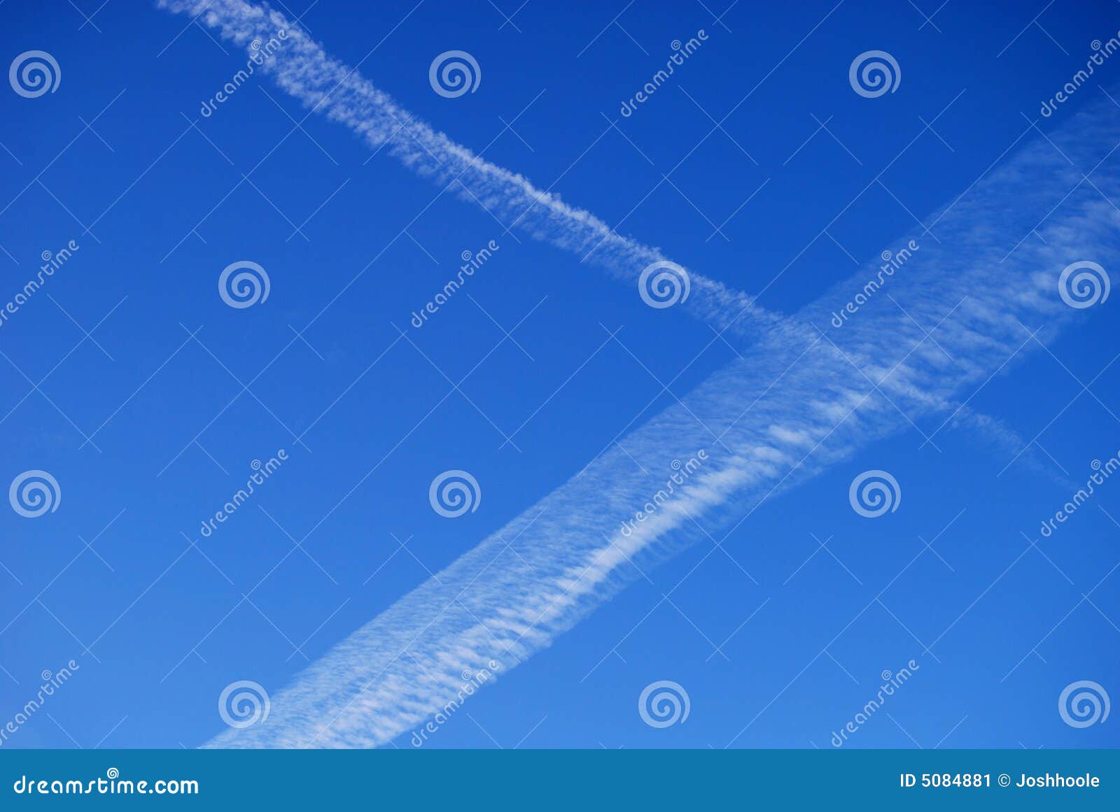 Jet Streams Crossing on a Clear, Deep Blue Sky Stock Image - Image of ...