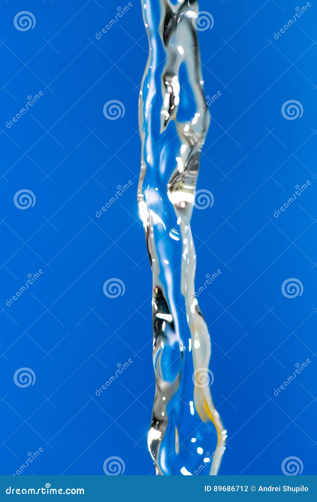 A Jet of Water on a Blue Background Stock Photo - Image of transparent ...