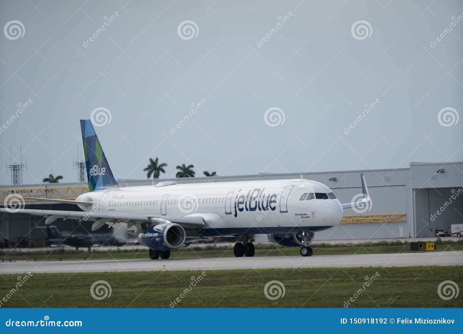 Photo Of A Jetblue Airplane On Sky Background Blue And Clouds ...