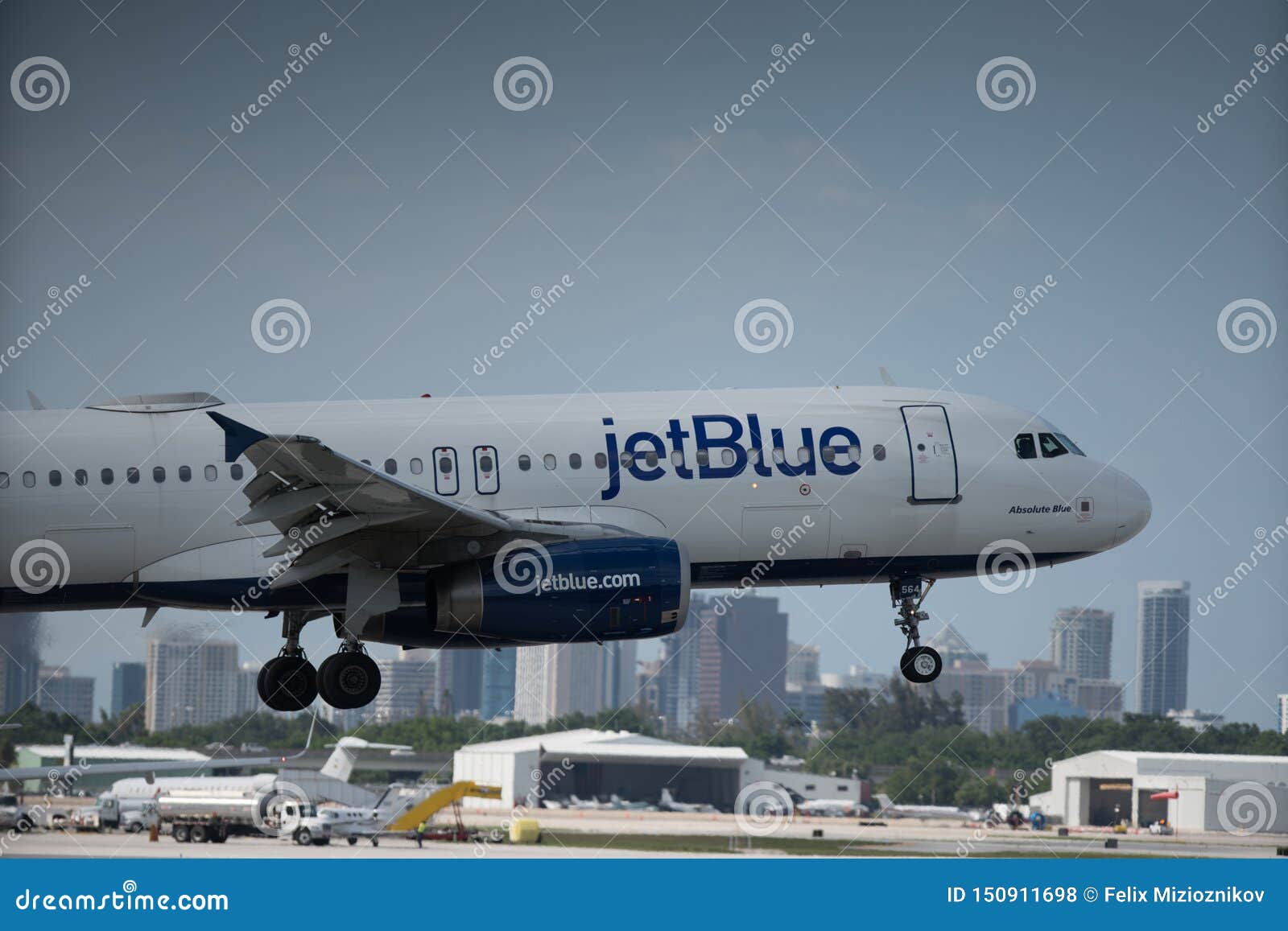 Photo Of A Jetblue Airplane On Sky Background Blue And Clouds ...