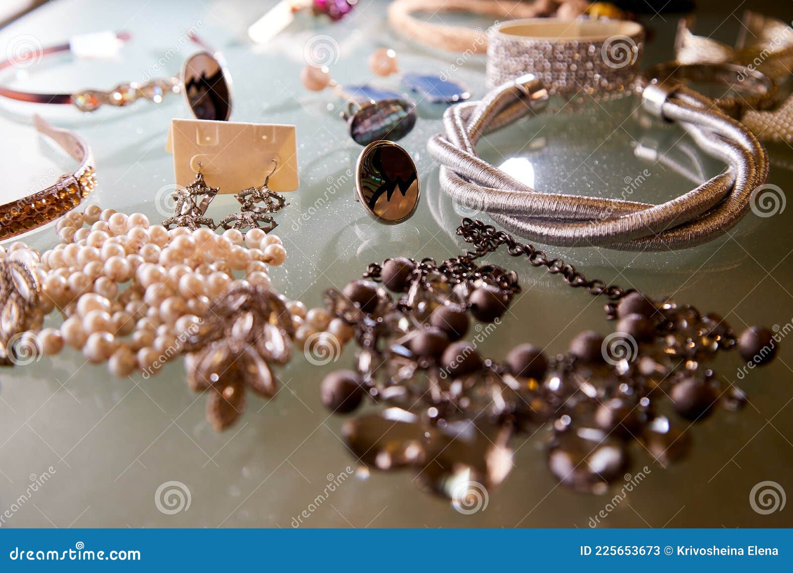 Jewelry for Women on a Glass Table Illuminated by an Interesting Light ...
