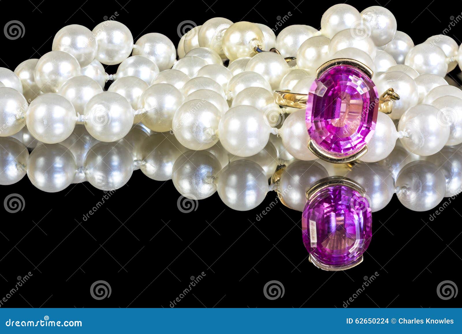 Jewlery on a Reflective Surface Stock Photo - Image of jewelry, string ...
