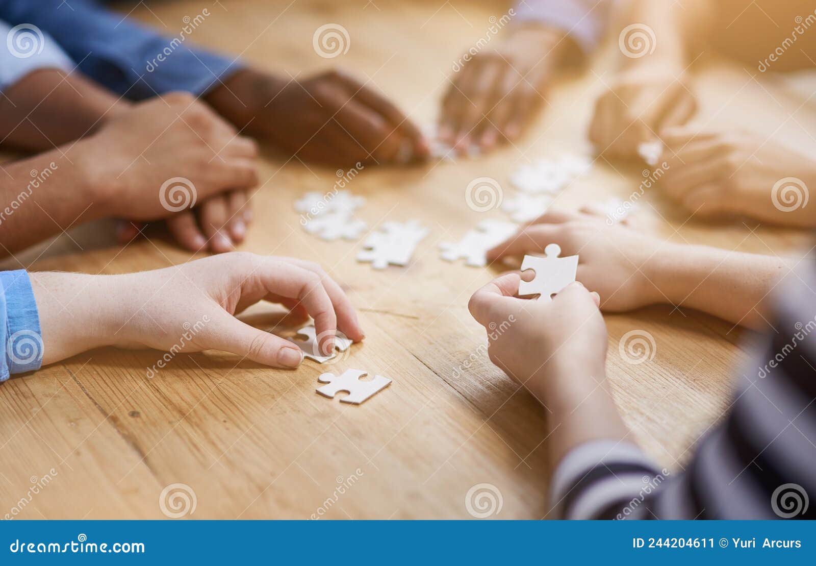 Jigsaw Solutions. Shot of a Group of People Building a Puzzle Together ...