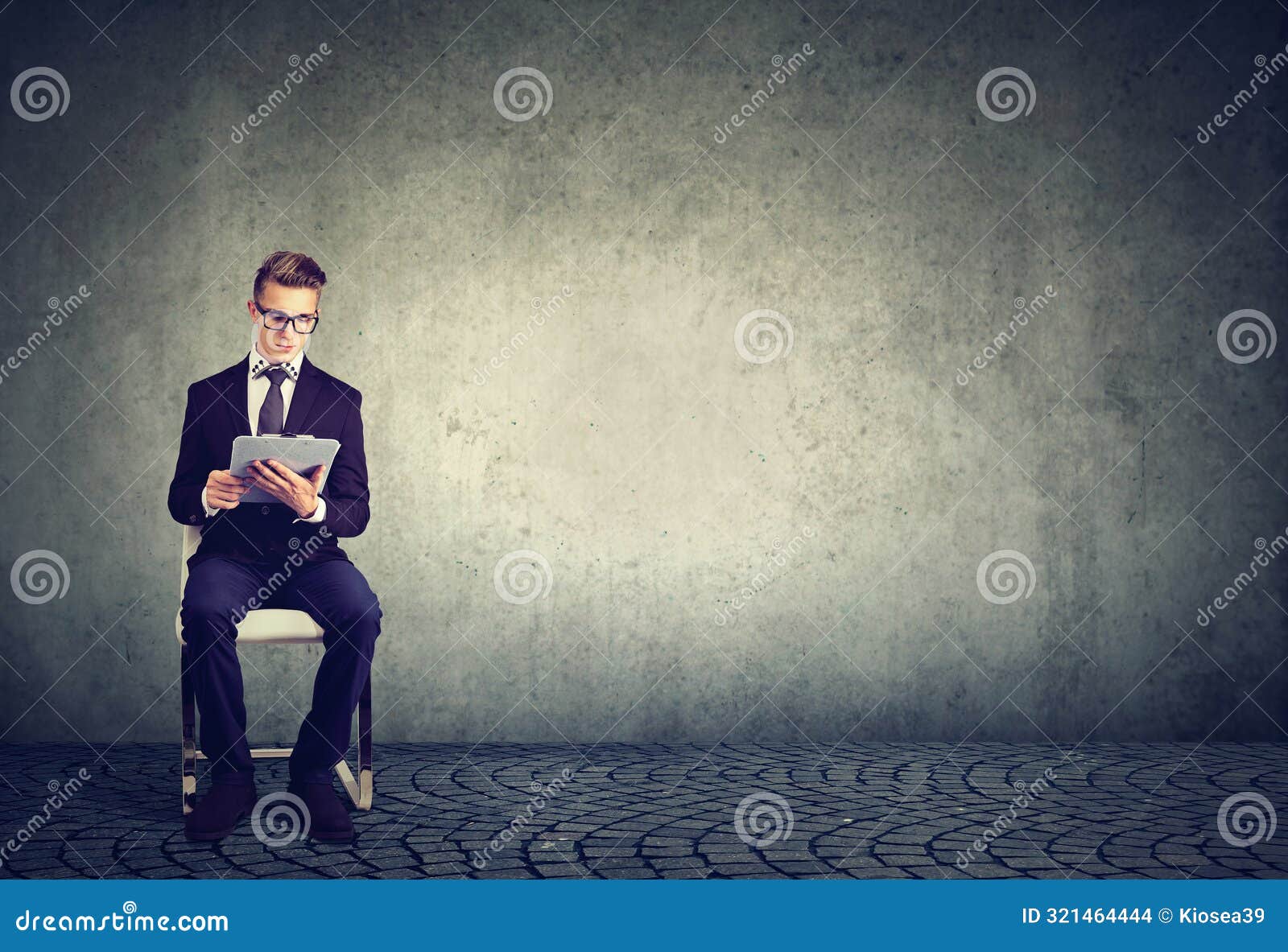 A Job Applicant Young Man Sitting on a Chair Reading a Contract Stock ...