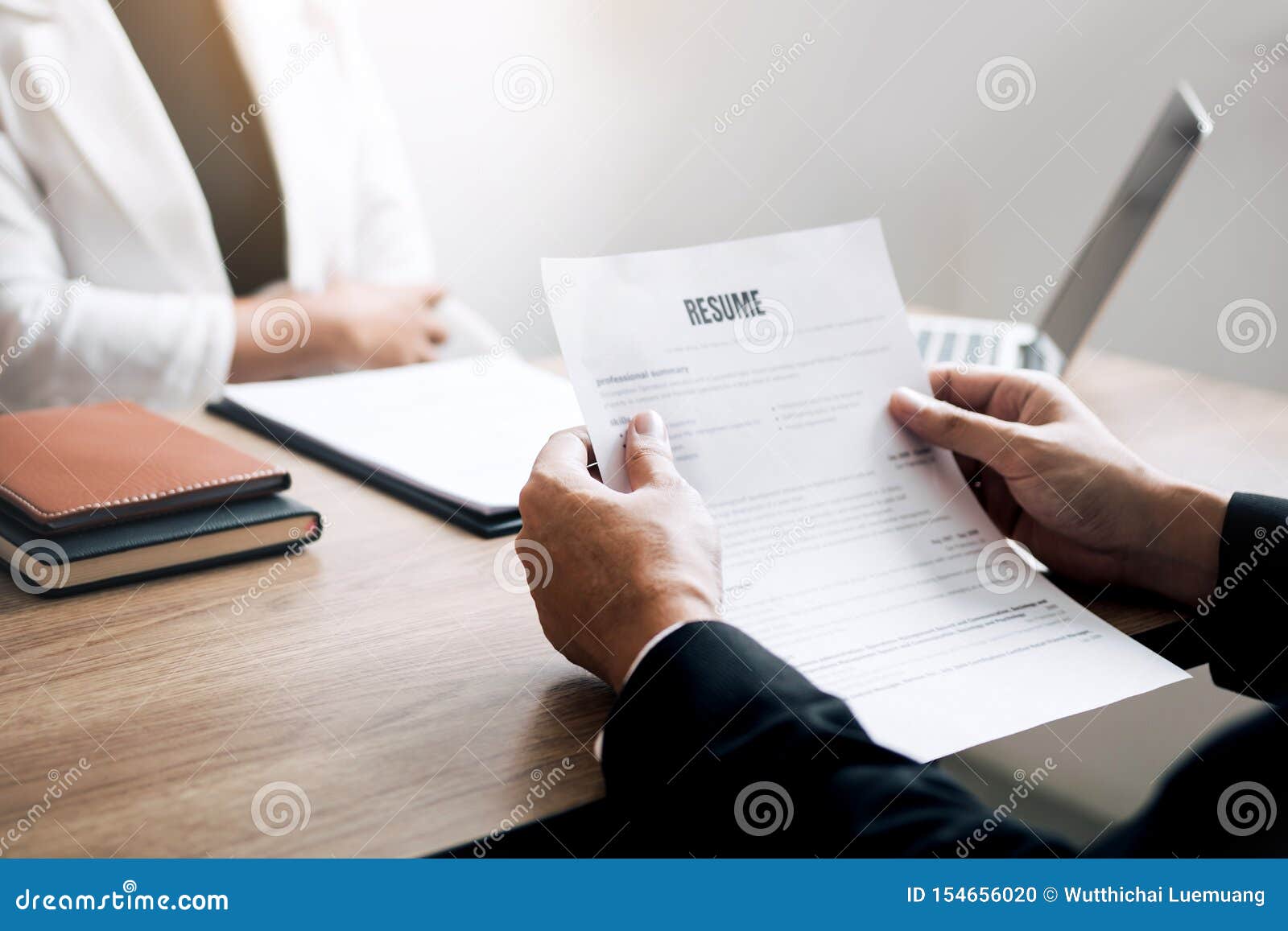 Job Applicants are Holding a Resume Document in the Job Interview Room ...