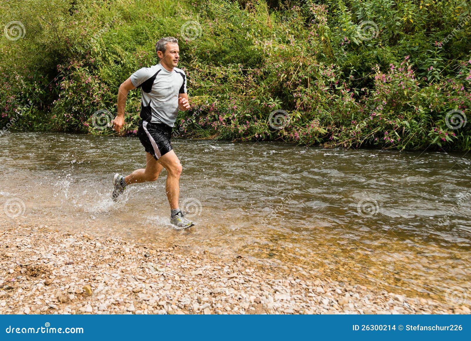 Jogger Running through a Streambed Stock Photo - Image of athlete ...
