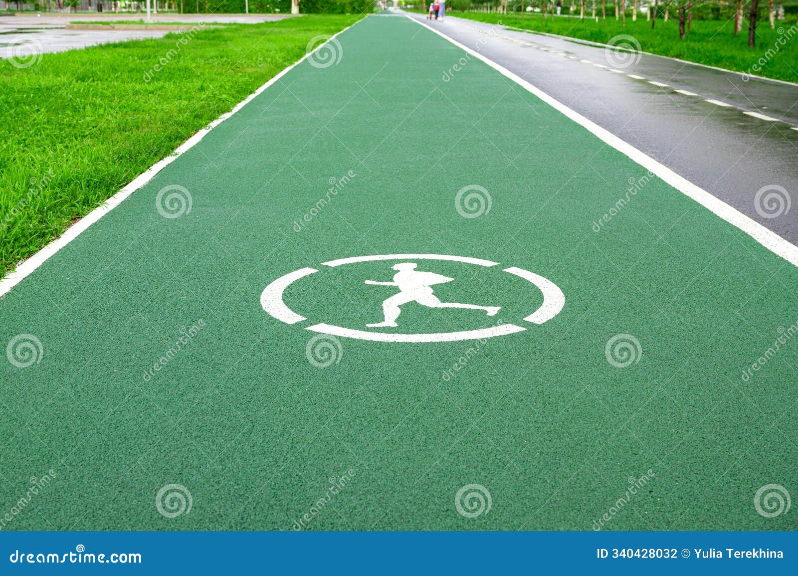 Jogging Path with White Runner Symbol Painted on Green Pavement ...
