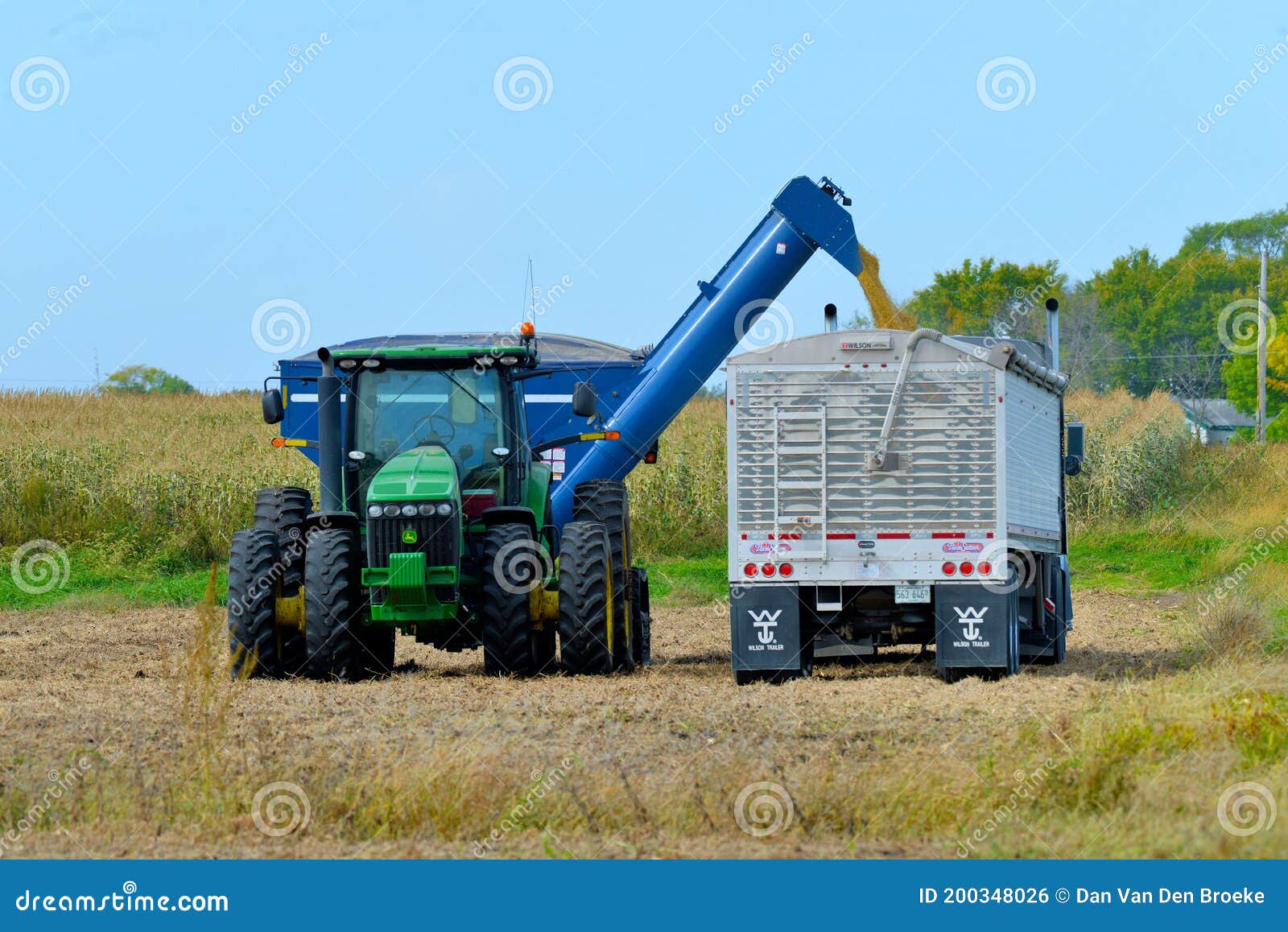 John Deere 8345R Tractor Unloading Corn from a Grain Wagon for ...