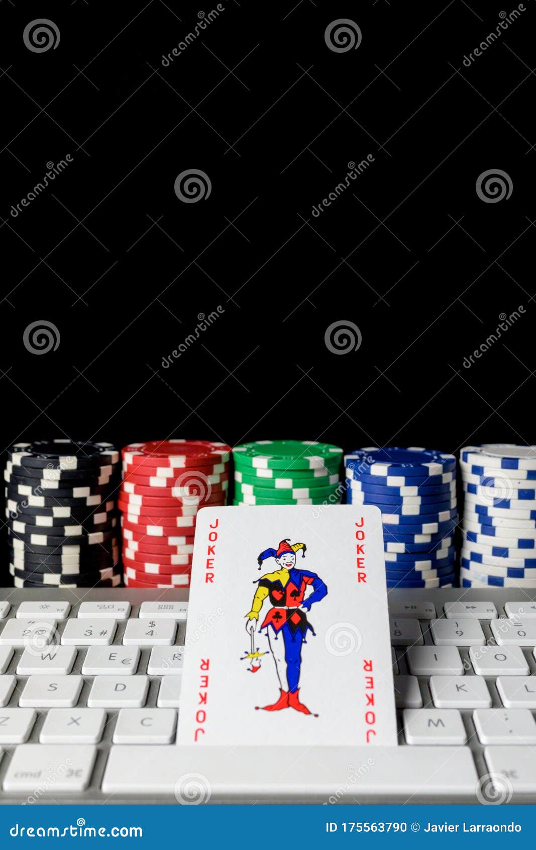 JOKER Poker Card on a Computer Keyboard with Poker Chips Placed in ...