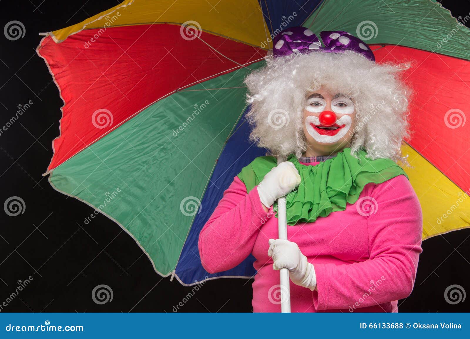 Jolly Good Funny Clown with a Multi-colored Umbrella on a Black Stock ...
